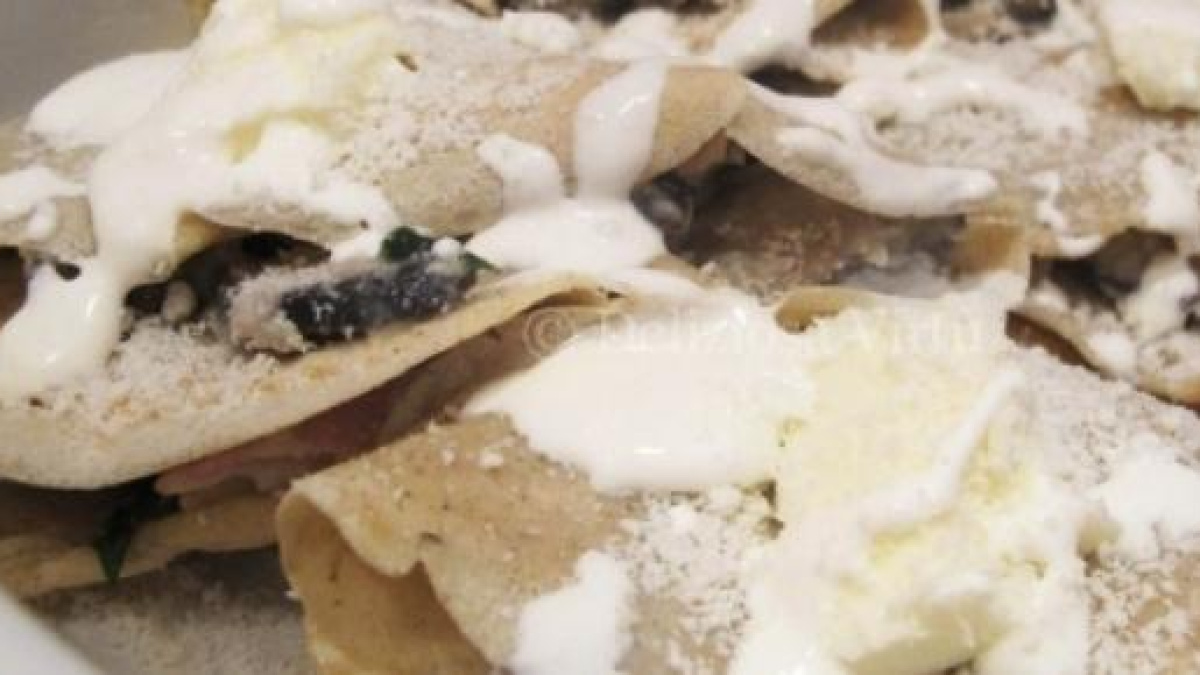 Crespelle di pasta ripiene, condite con salsa alle noci